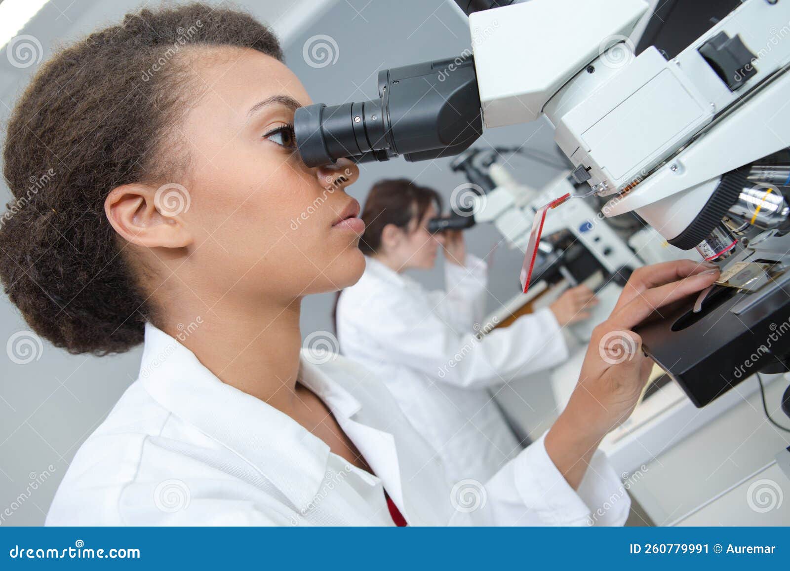 Woman Looking through Microscope in Lab Stock Image - Image of ...
