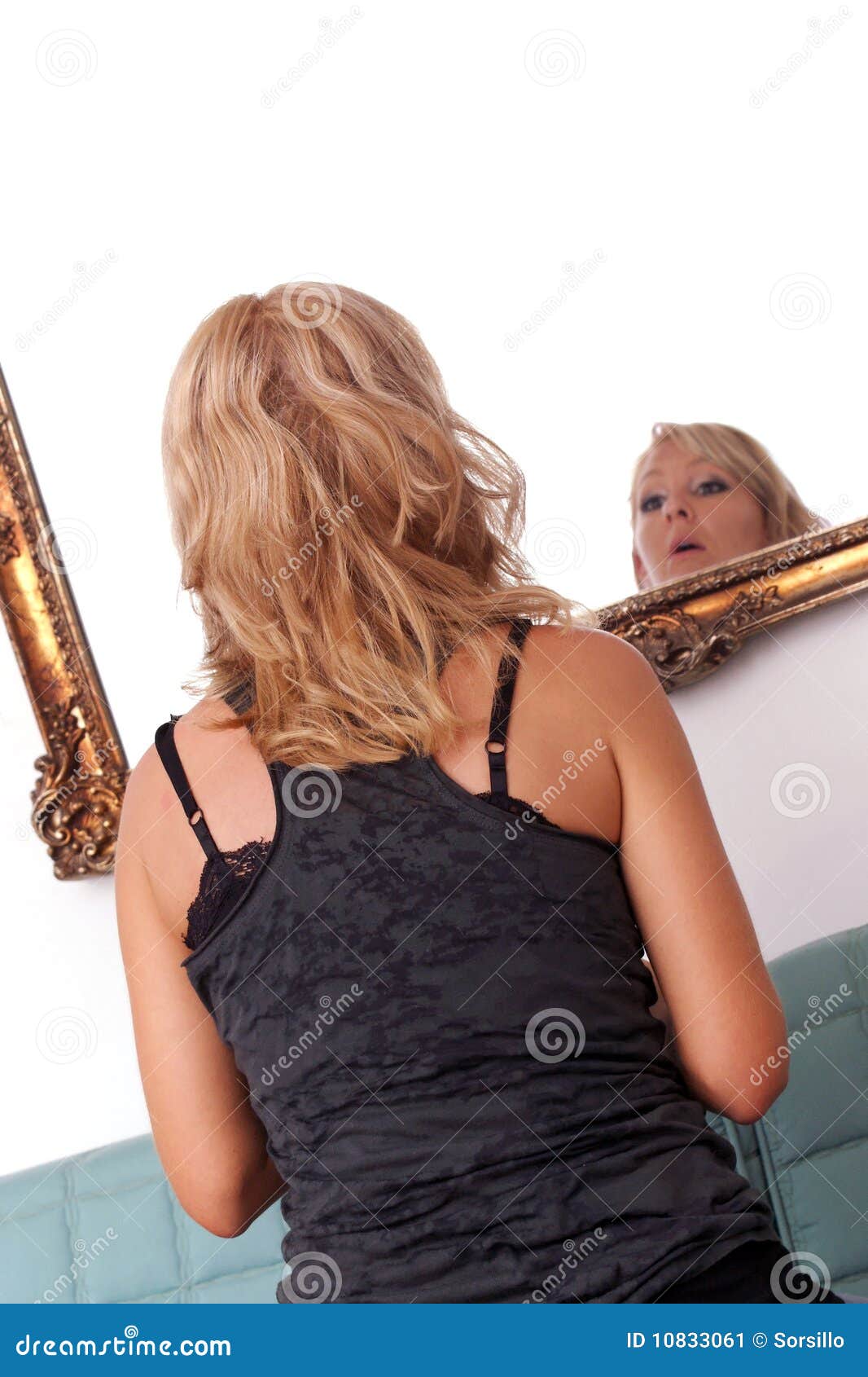Woman looking in mirror stock image. Image of face, back - 10833061