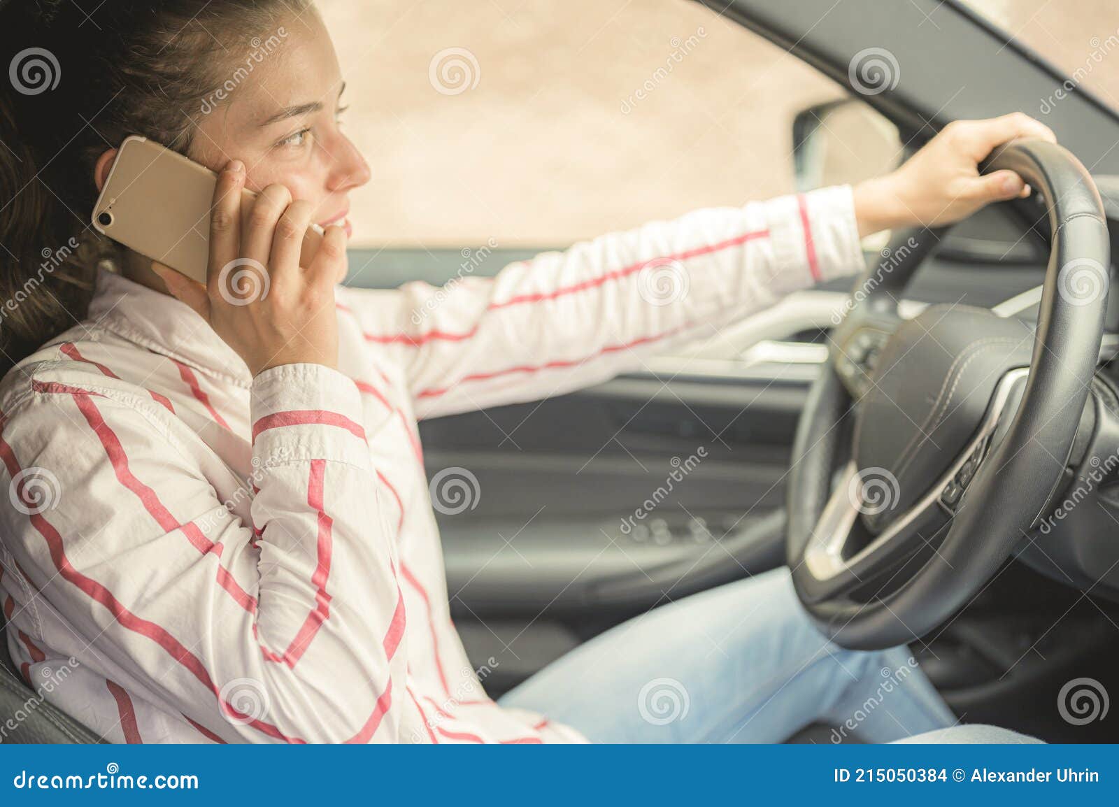 Woman Looking at Mobile Phone while Driving a Car. Driver Using Smart ...