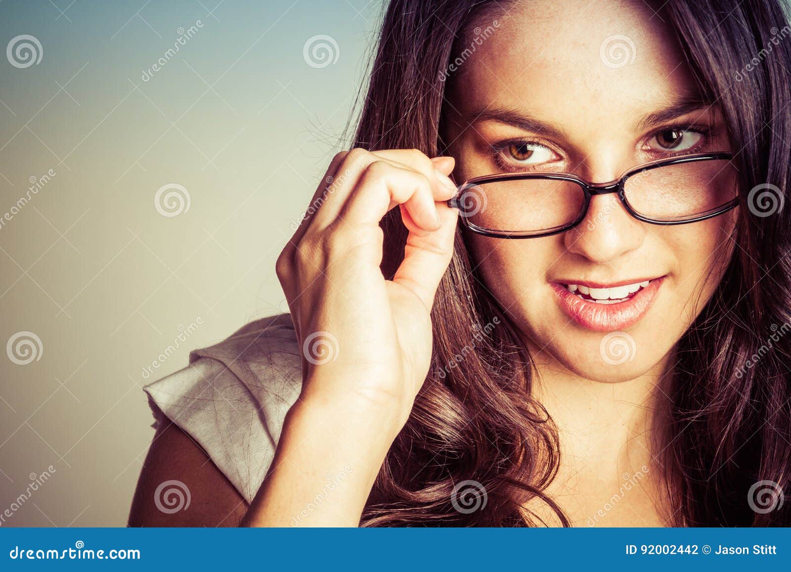 Woman Looking Over Glasses stock photo. Image of beauty - 92002442