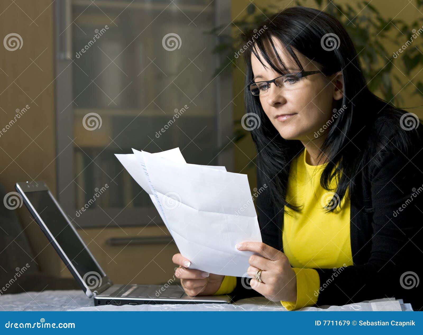 Woman Looking Over Paperwork Stock Image - Image of caucasian, works ...