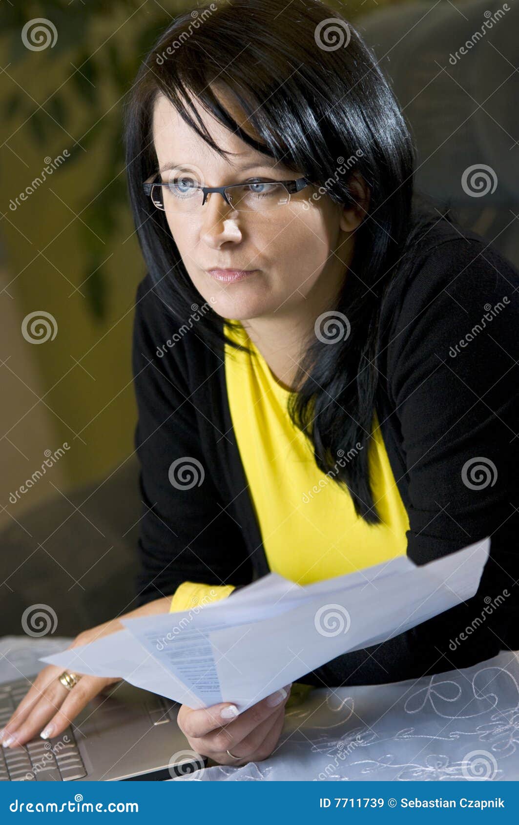 Woman Looking Over Paperwork Stock Image - Image of bill, female: 7711739