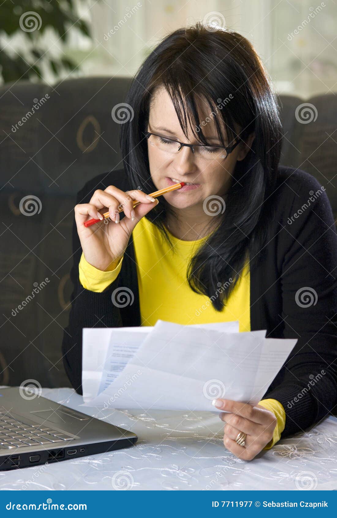 Woman Looking Over Paperwork Stock Image - Image of paperwork, brunette ...