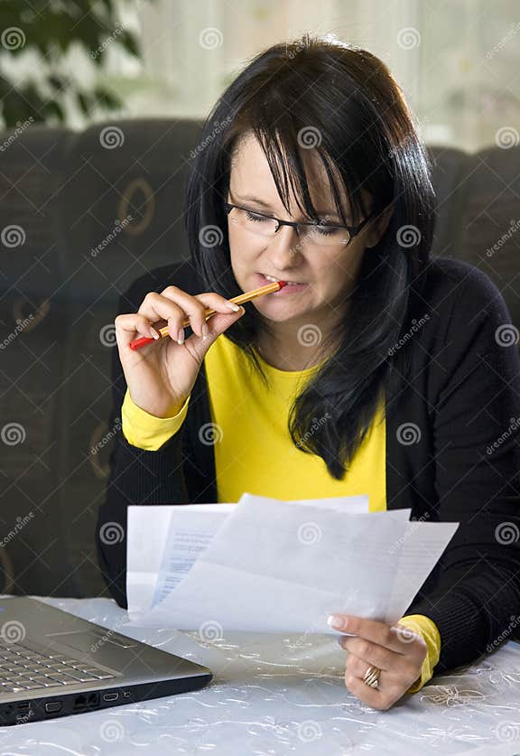 Woman Looking Over Paperwork Stock Image - Image of paperwork, brunette ...