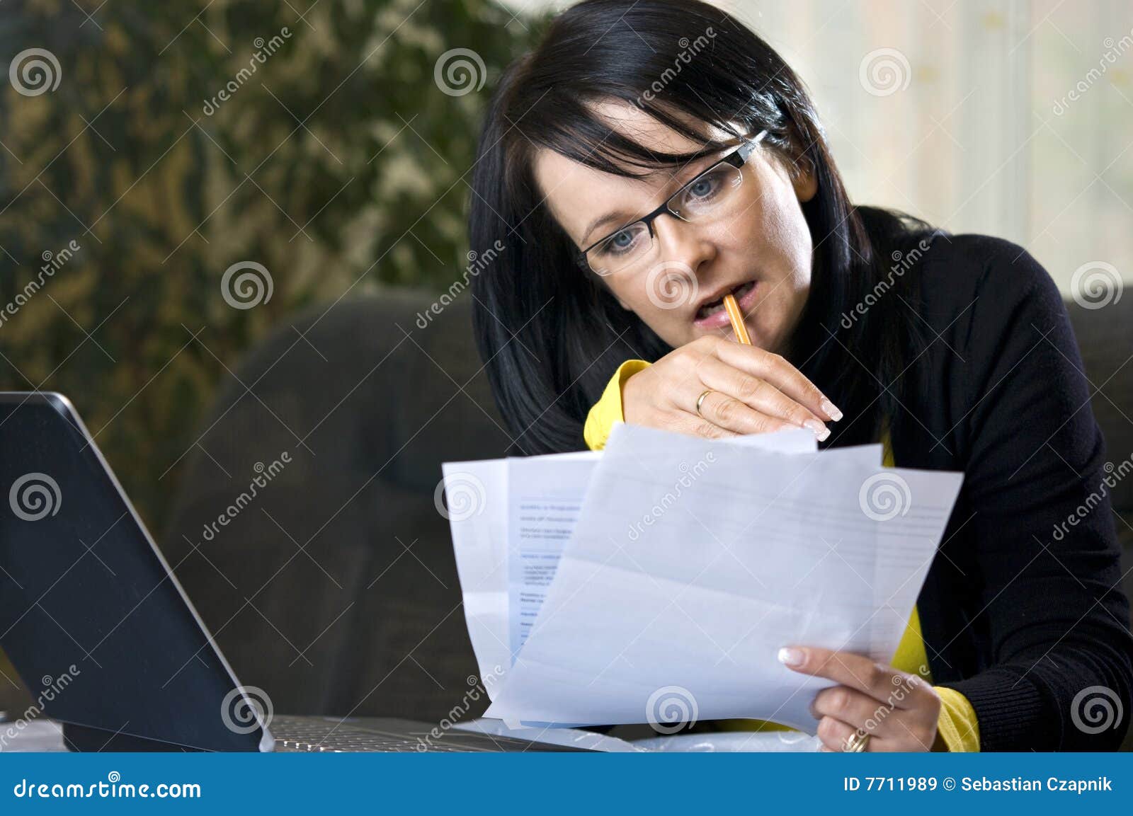 Woman Looking Over Paperwork Stock Image - Image of bills, papers: 7711989