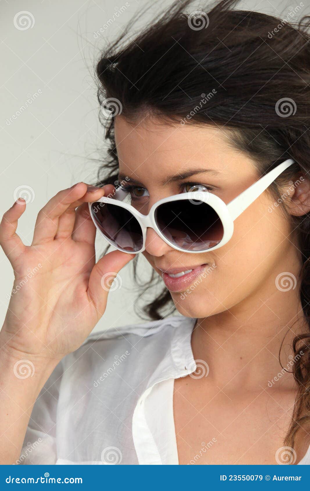 Woman Looking Over Sunglasses Stock Image - Image of gentle, hold: 23550079