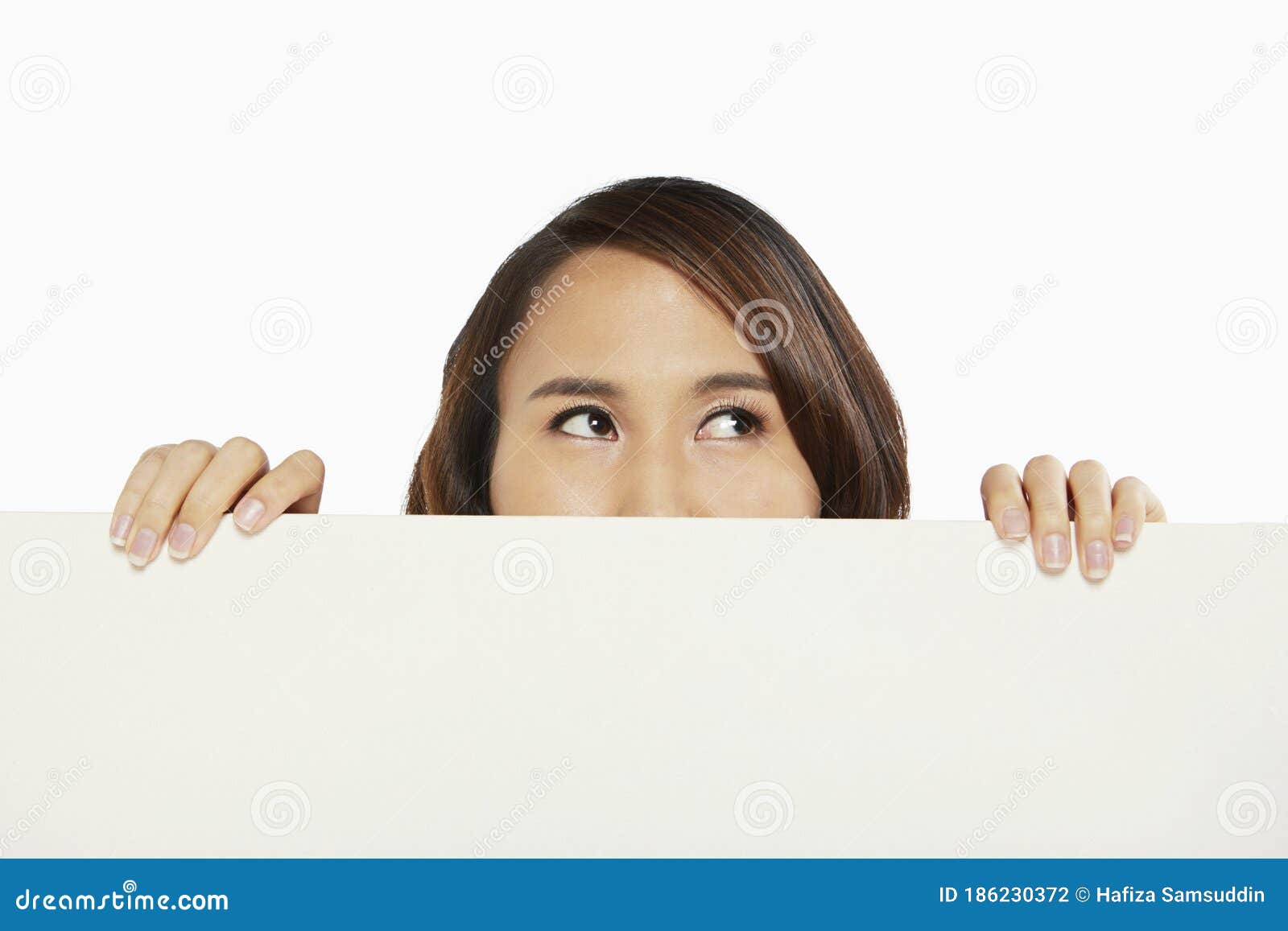 Woman looking over a wall stock photo. Image of front - 186230372
