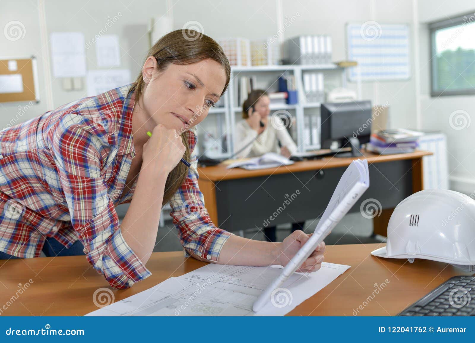 Woman looking at plans stock photo. Image of build, hardhat - 122041762