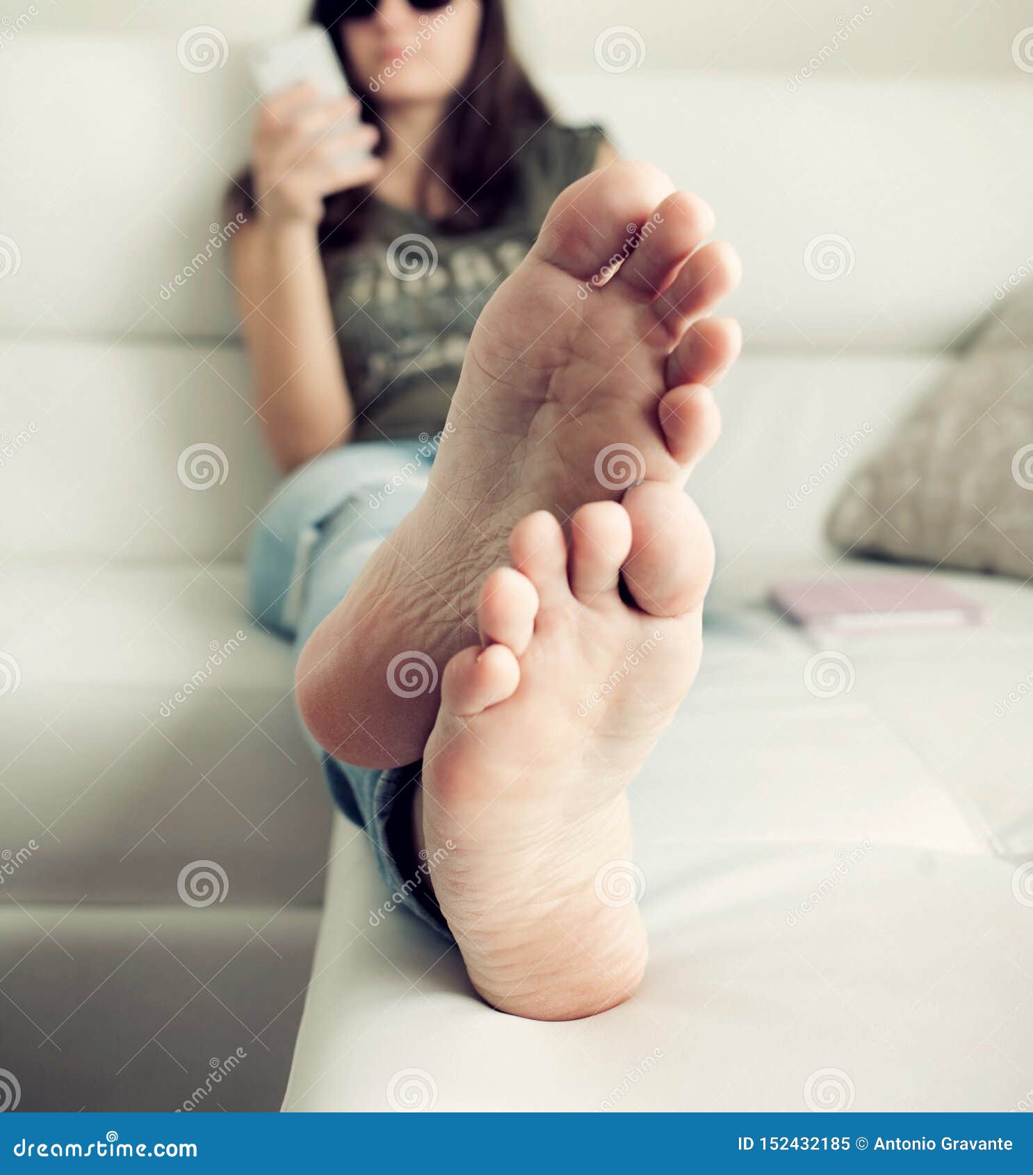Woman Looking Smartphonewith Feet in the Foreground Stock Image - Image ...
