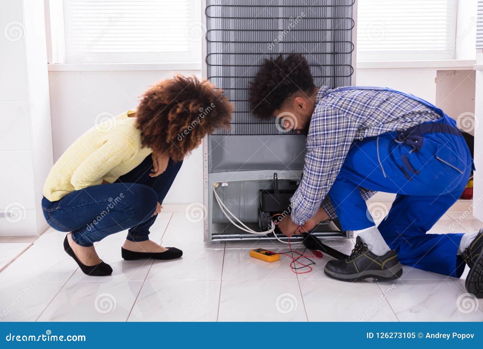 Technician Examining Refrigerator with Digital Multimeter Stock Image ...