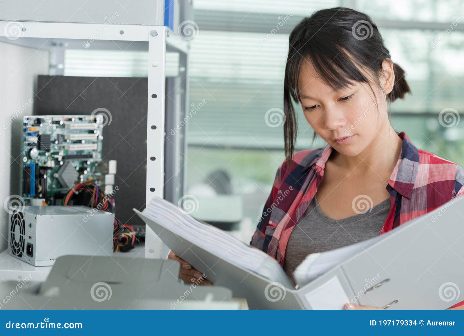 Woman Looking Up Information in Large Office Binder Stock Photo - Image ...