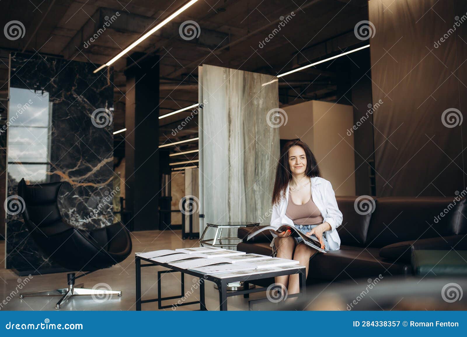 A Woman Looks at a Catalog of Goods in a Hardware Store Stock Image ...