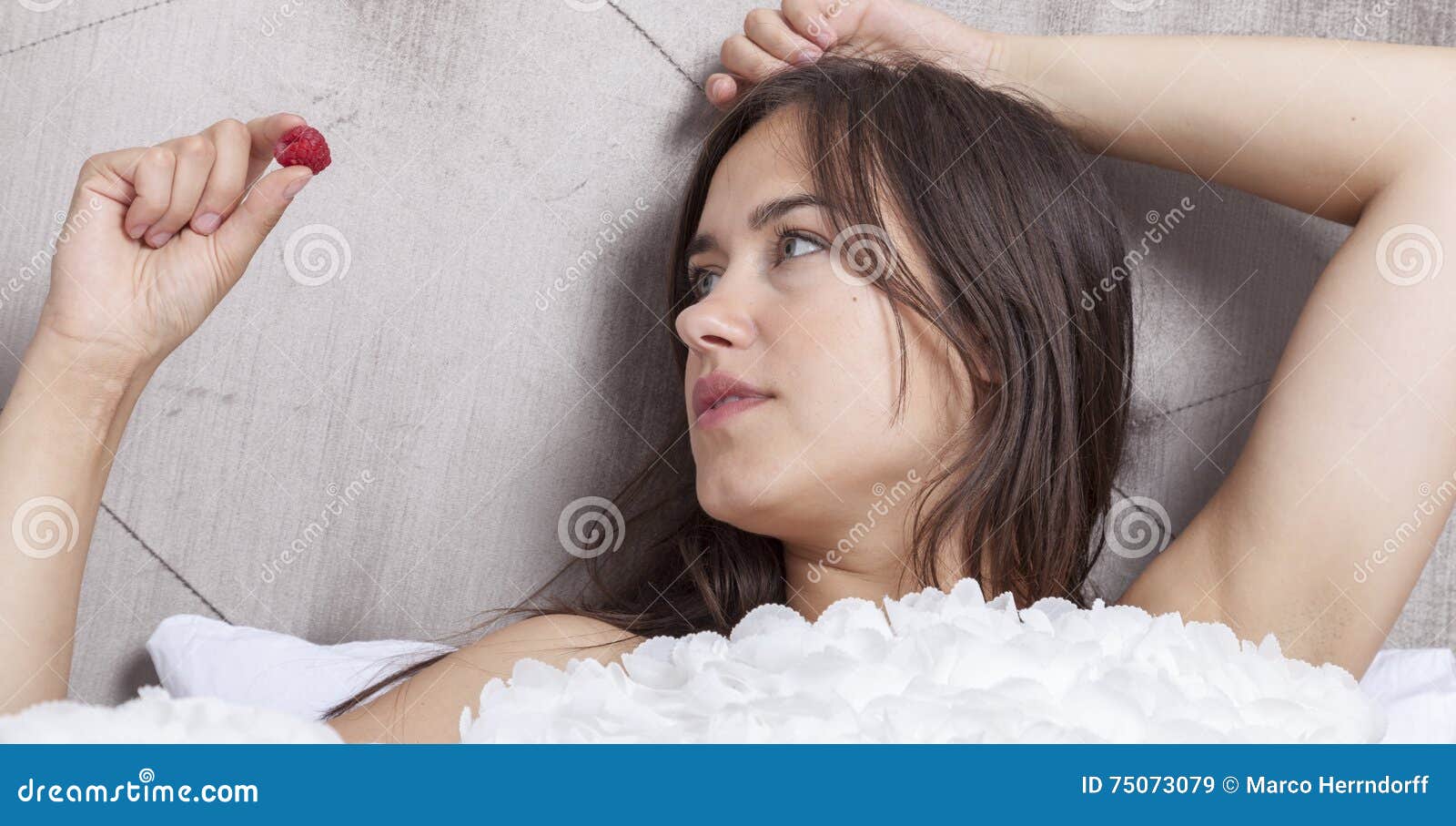 Woman looks at raspberry stock image. Image of cuddle - 75073079