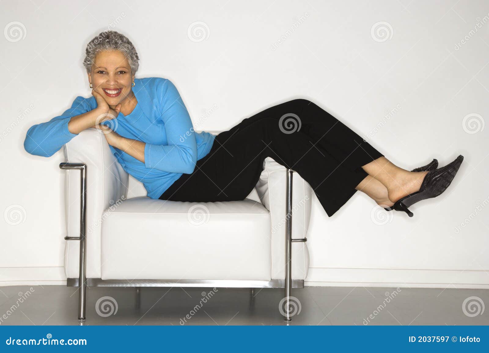 Woman lying back on chair. stock image. Image of middle - 2037597