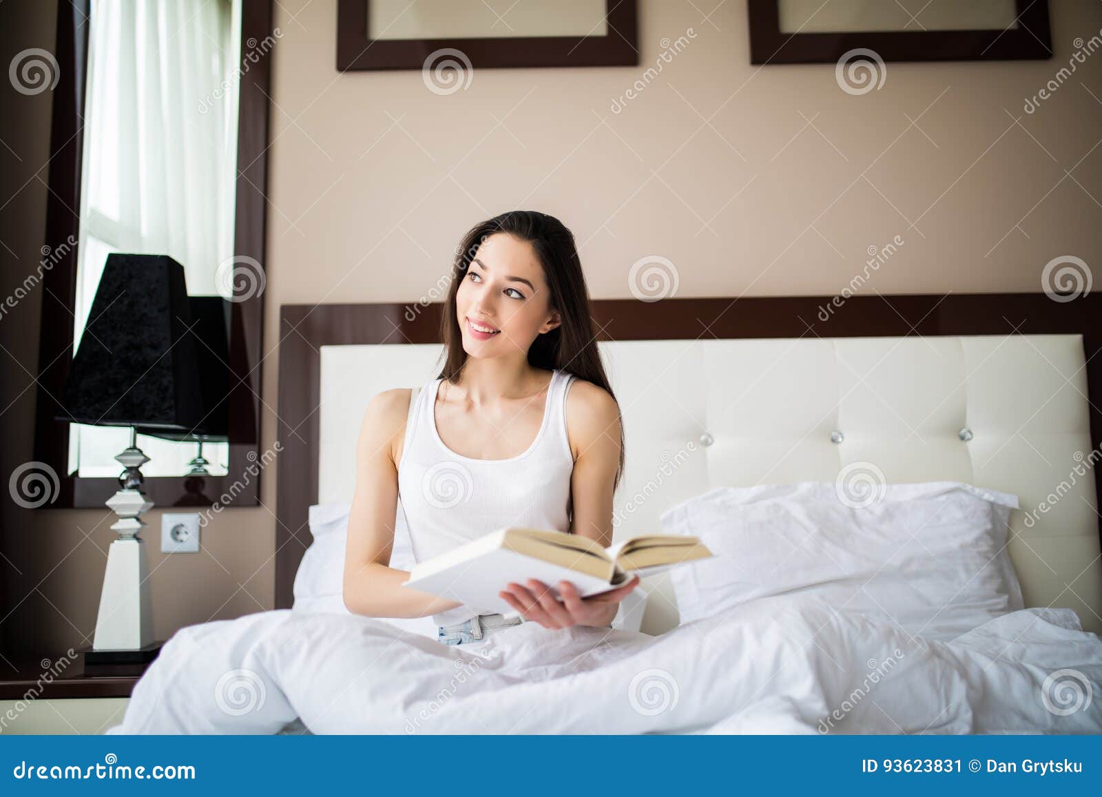 Woman Lying in Bed while Reading a Book at Home Stock Image - Image of ...
