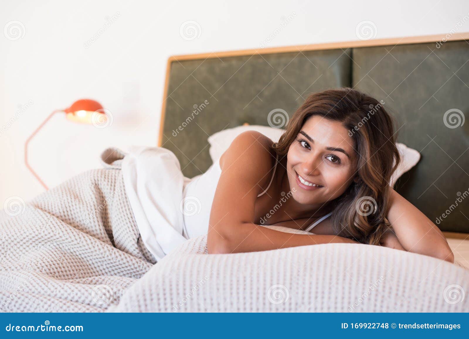 Woman Lying on the Bed Smiling Stock Photo - Image of smiling, toothy ...