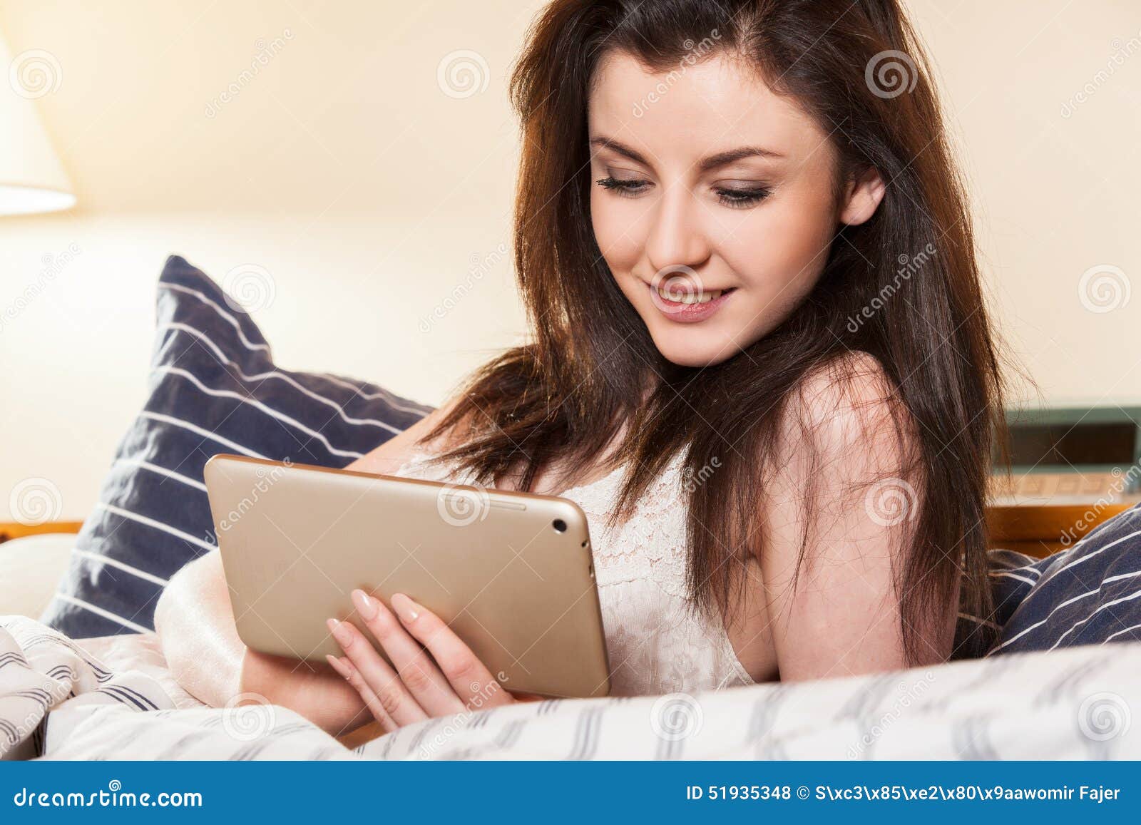 Woman Lying on the Bed and Using Tablet Stock Photo - Image of portrait ...