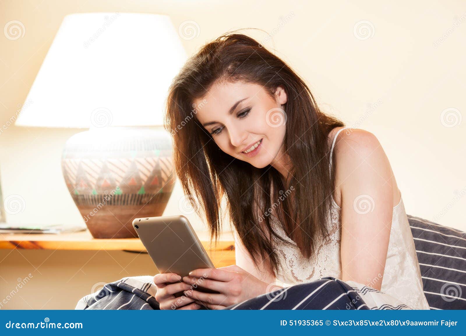 Woman Lying on the Bed and Using Tablet Stock Image - Image of looking ...