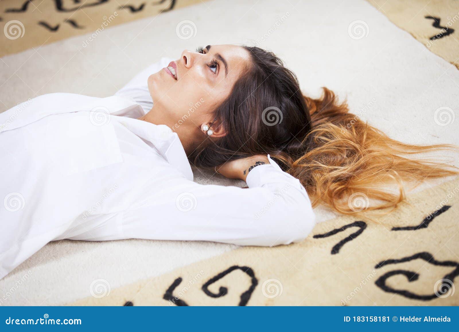 Woman lying in the carpet stock image. Image of floor - 183158181