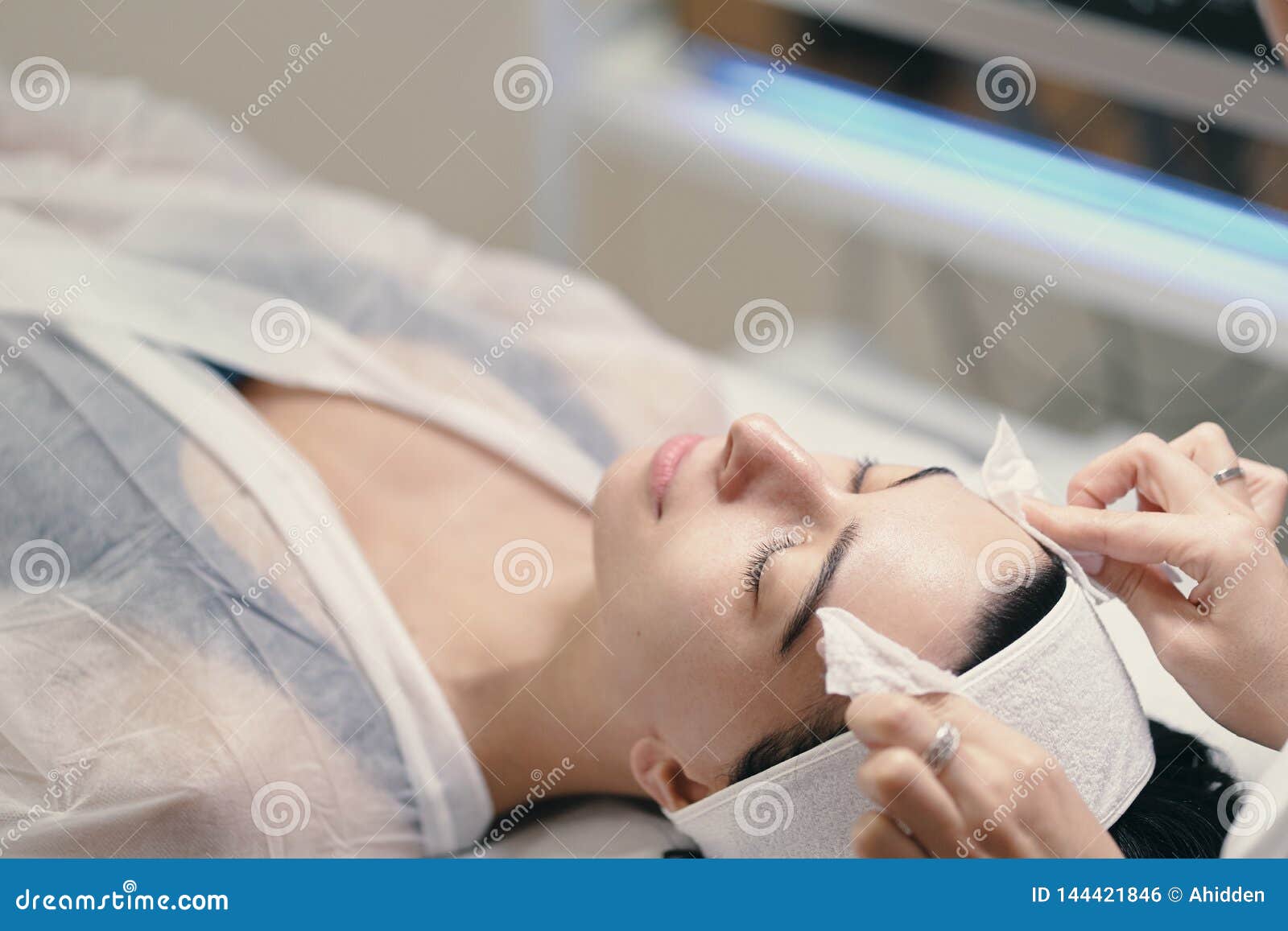Female Cosmetologist Making Facial Treatment To A Beautiful Woma Stock