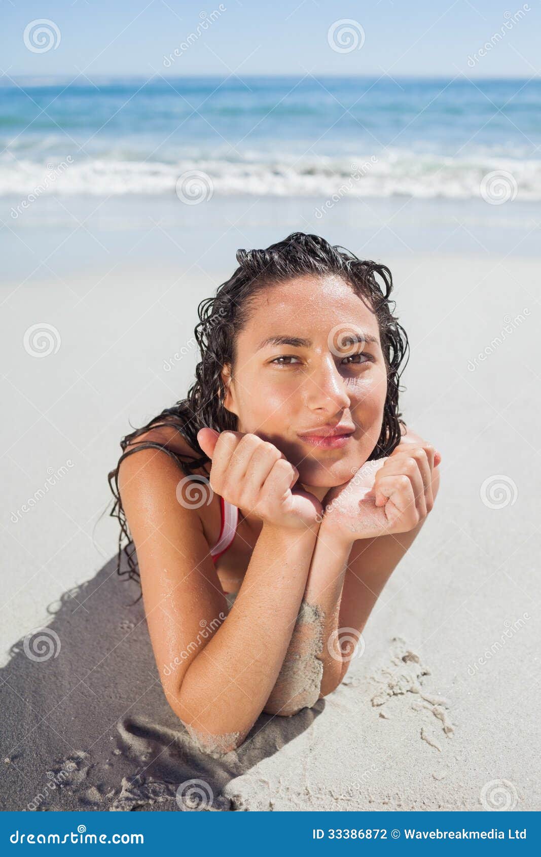 Woman lying down at beach stock photo. Image of bikini - 33386872