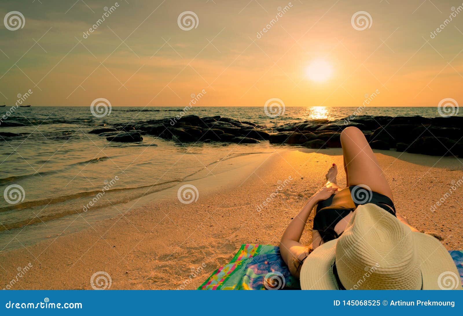 Woman Lying Down On Sand Beach At Sunrise Woman With Straw Hat