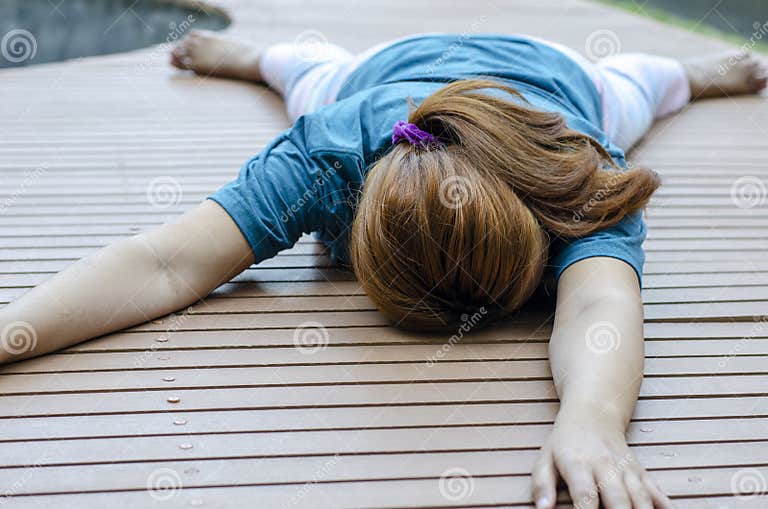 Woman Lying Face Down Fainting Because Of Hot Weather Stock Image