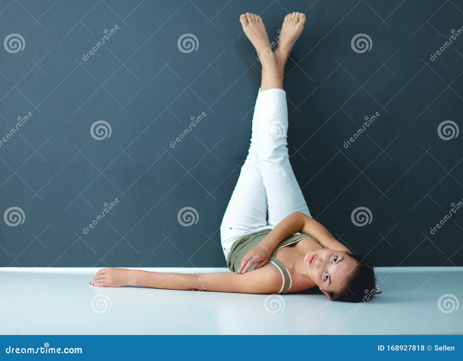 A Woman Lying on the Floor with Legs Up Stock Photo - Image of cheerful ...
