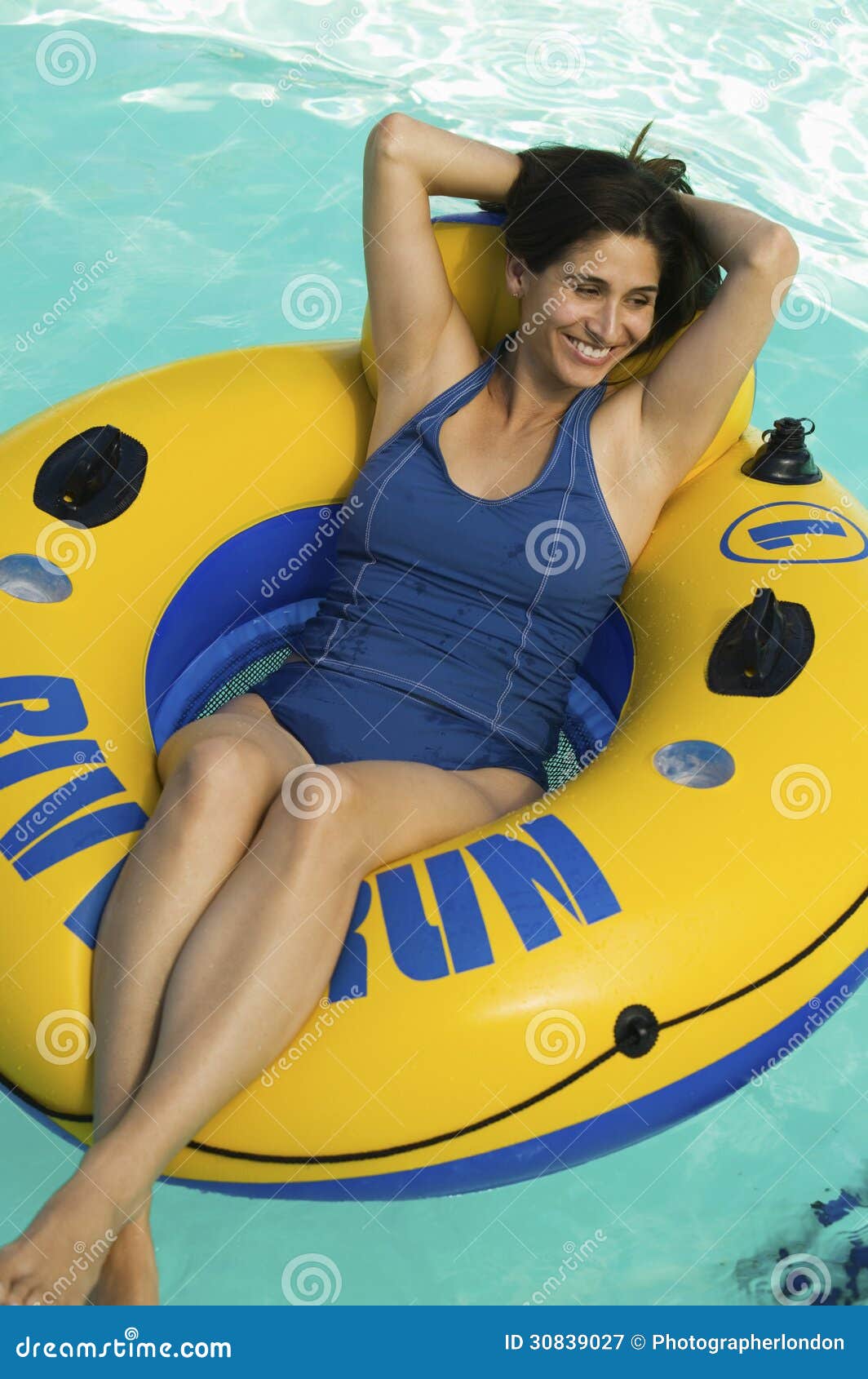 Woman Lying On Inflatable Raft In Swimming Pool Elevated View. Stock ...