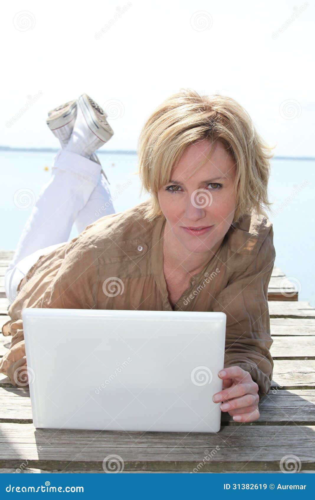 Woman lying on a jetty stock image. Image of trendy, internet - 31382619