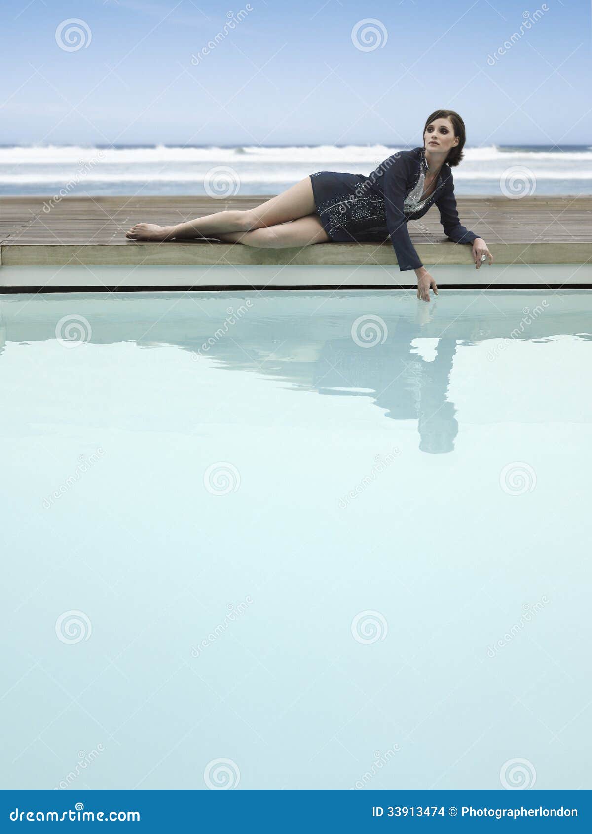 Woman Lying by Pool stock photo. Image of luxury, copyspace - 33913474