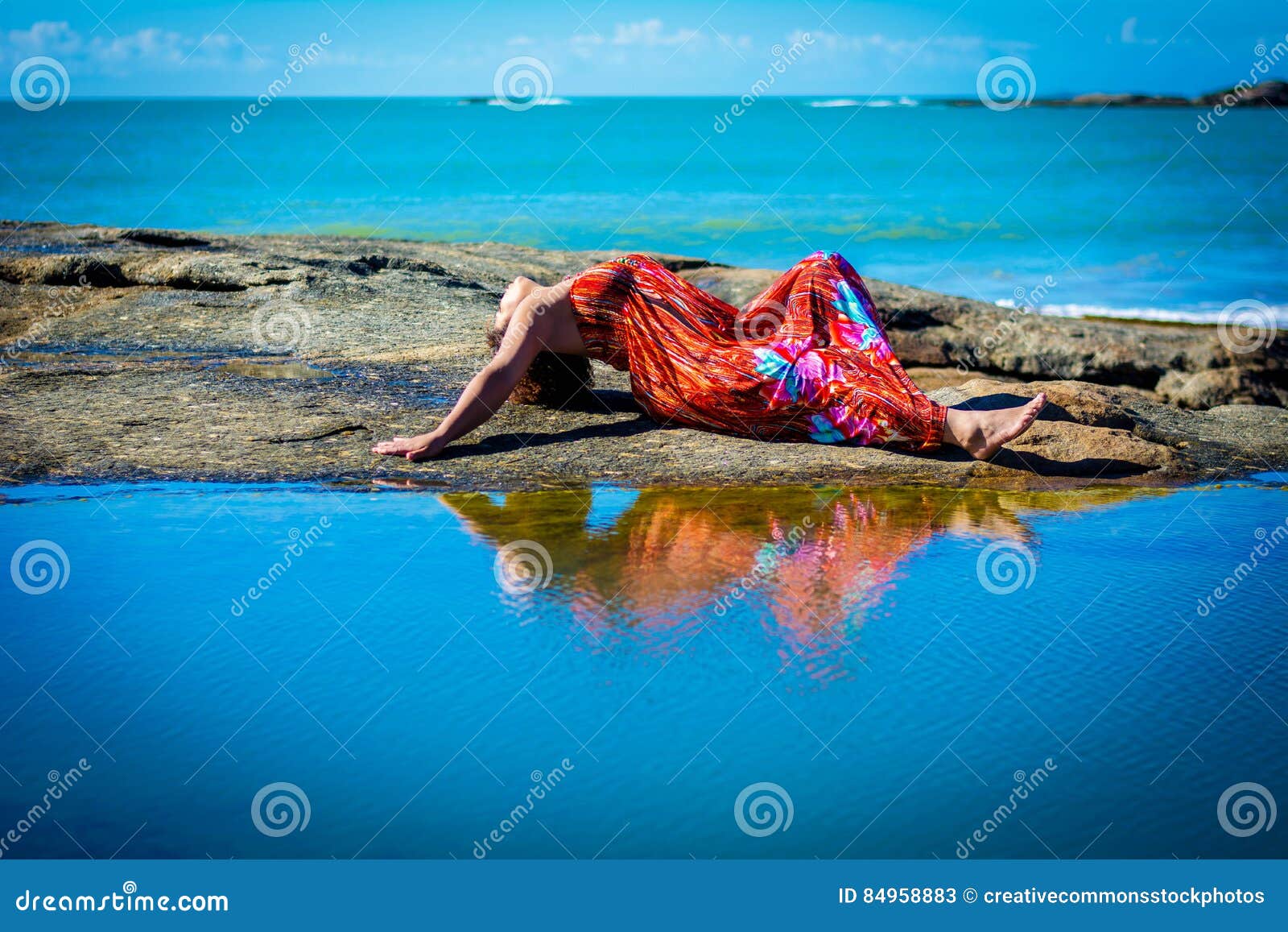Woman Lying On Rocks By Sea Picture. Image: 84958883