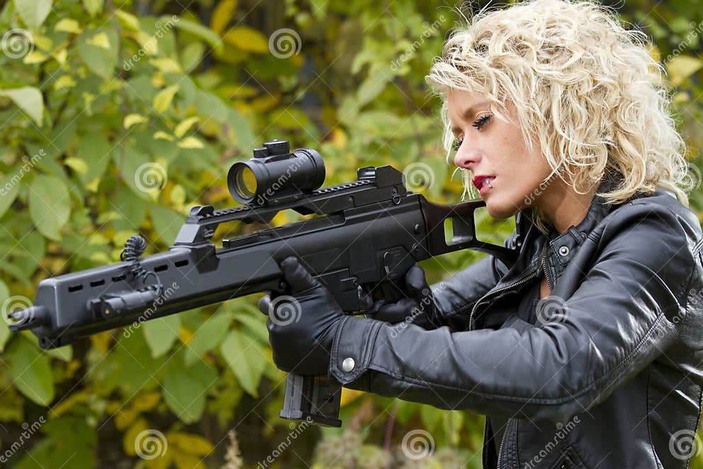Woman with machine gun stock photo. Image of shooter - 27333852