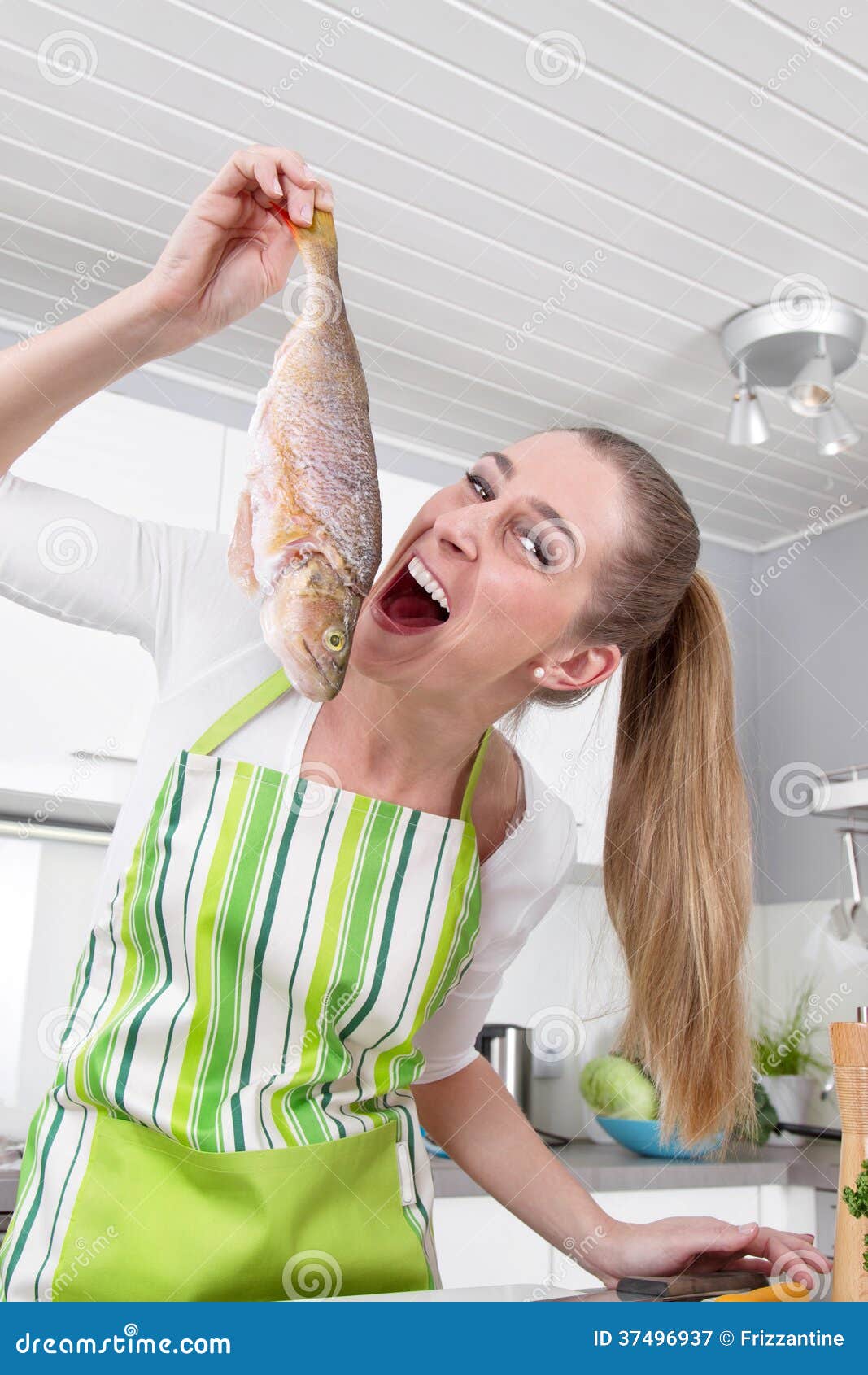 Woman is Making Fun with Fresh Fish - Perch/pike - at Kitchen. Stock ...