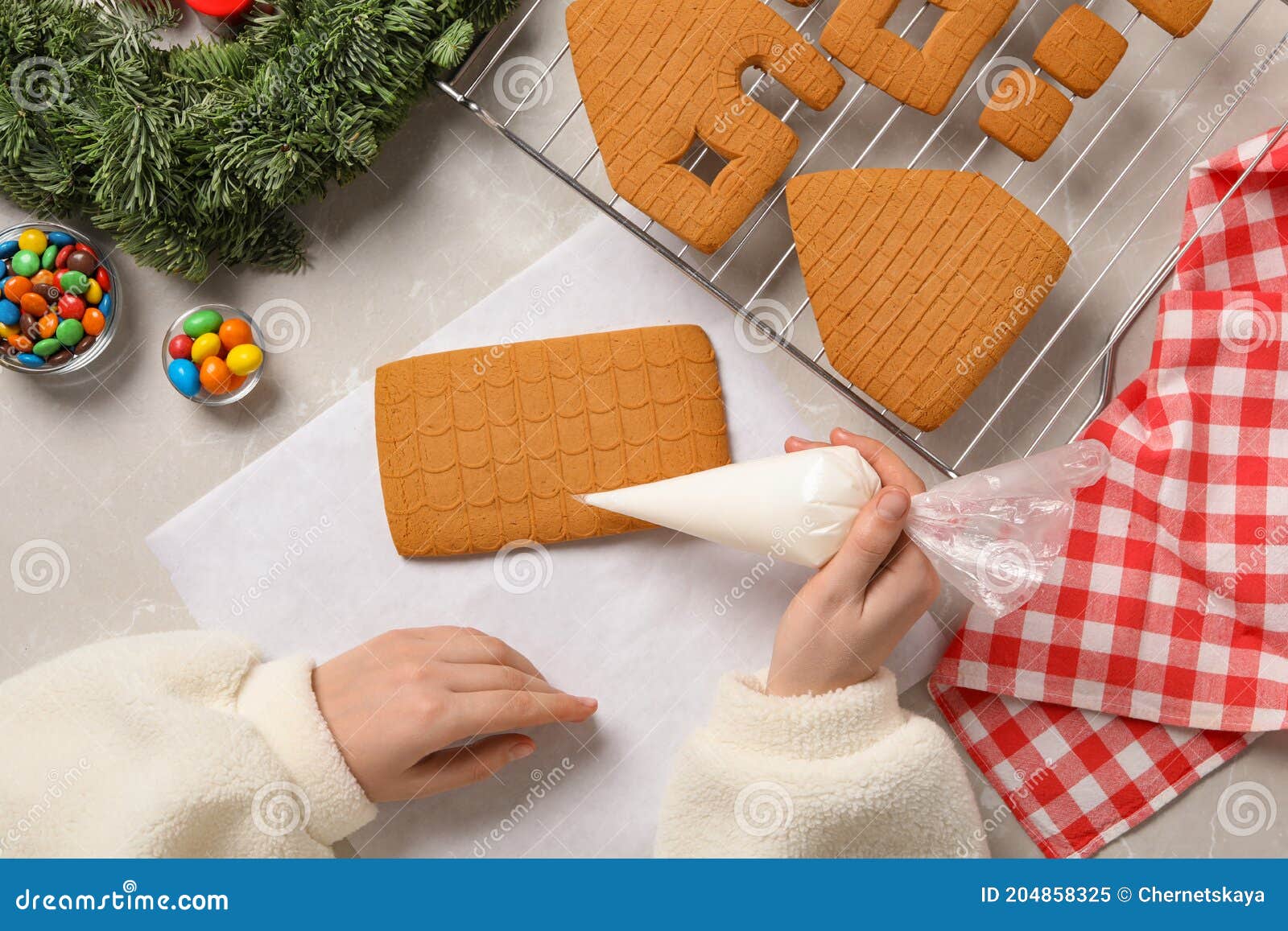 Woman Making Gingerbread House at Light Grey Marble Table, Top View ...