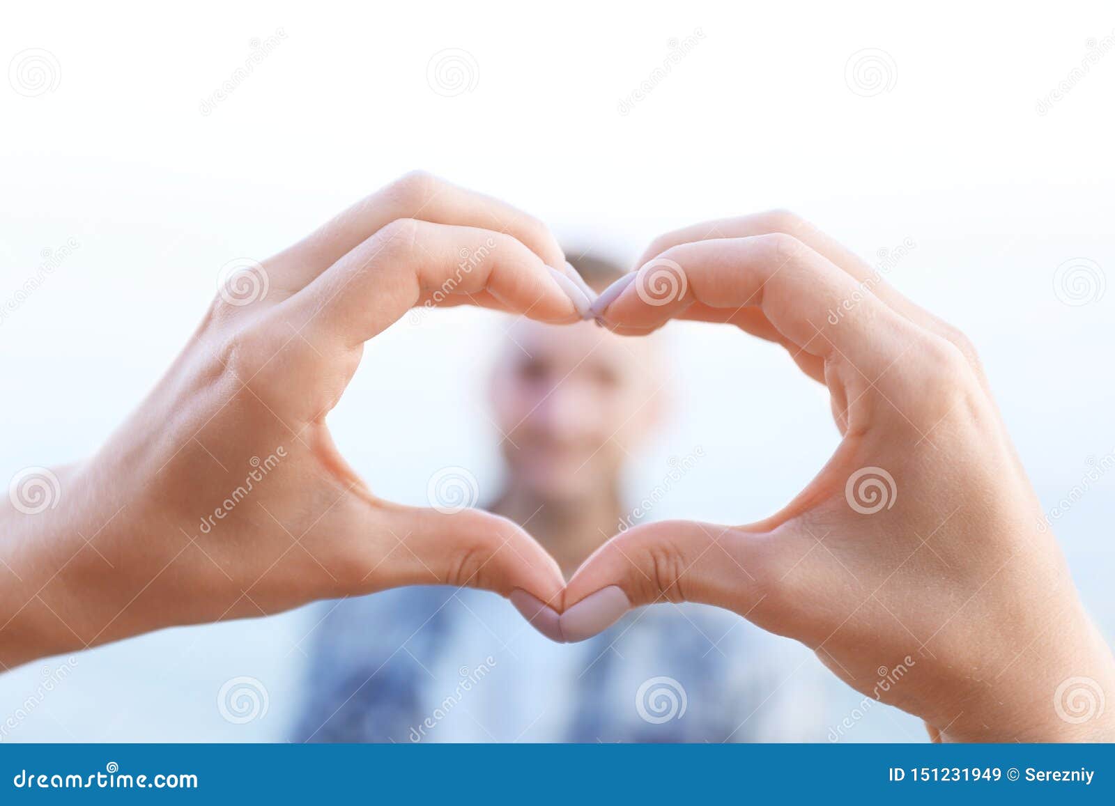 Woman Making Heart-shaped Frame with Her Hands for Young Man Stock ...