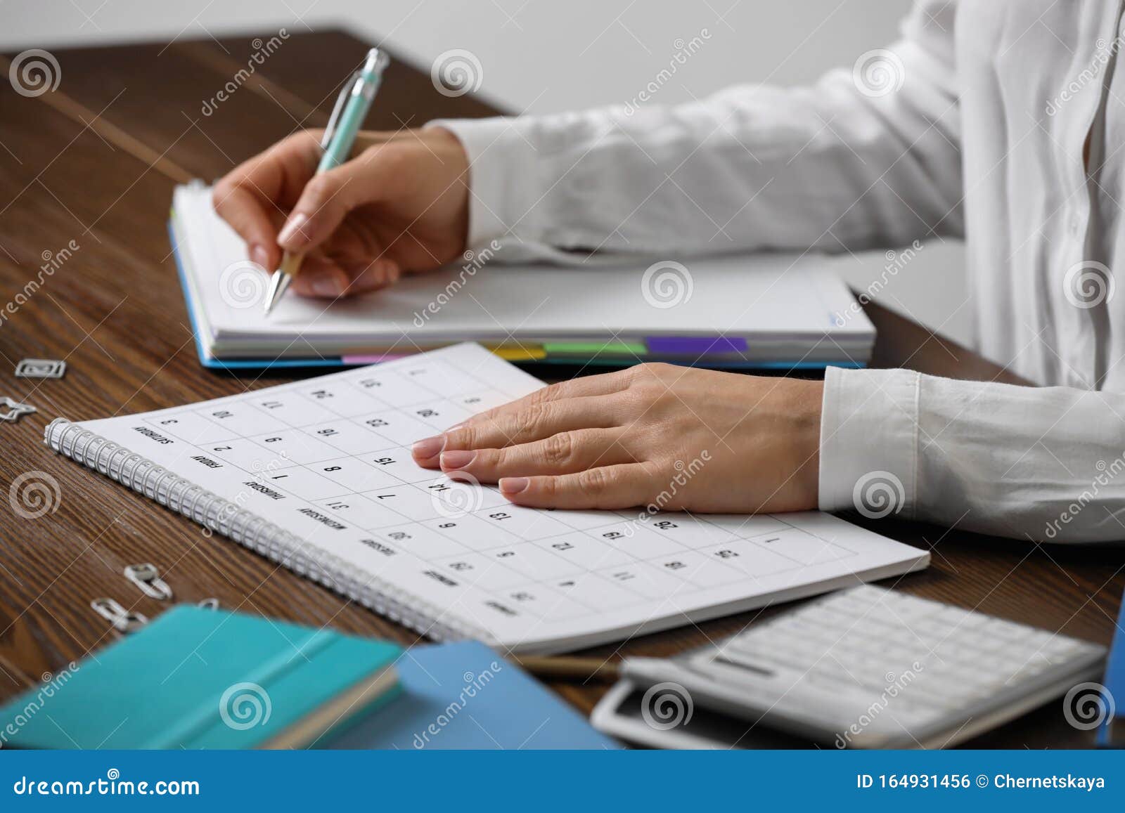 Woman Making Schedule Using Calendar at Table, Closeup Stock Photo ...