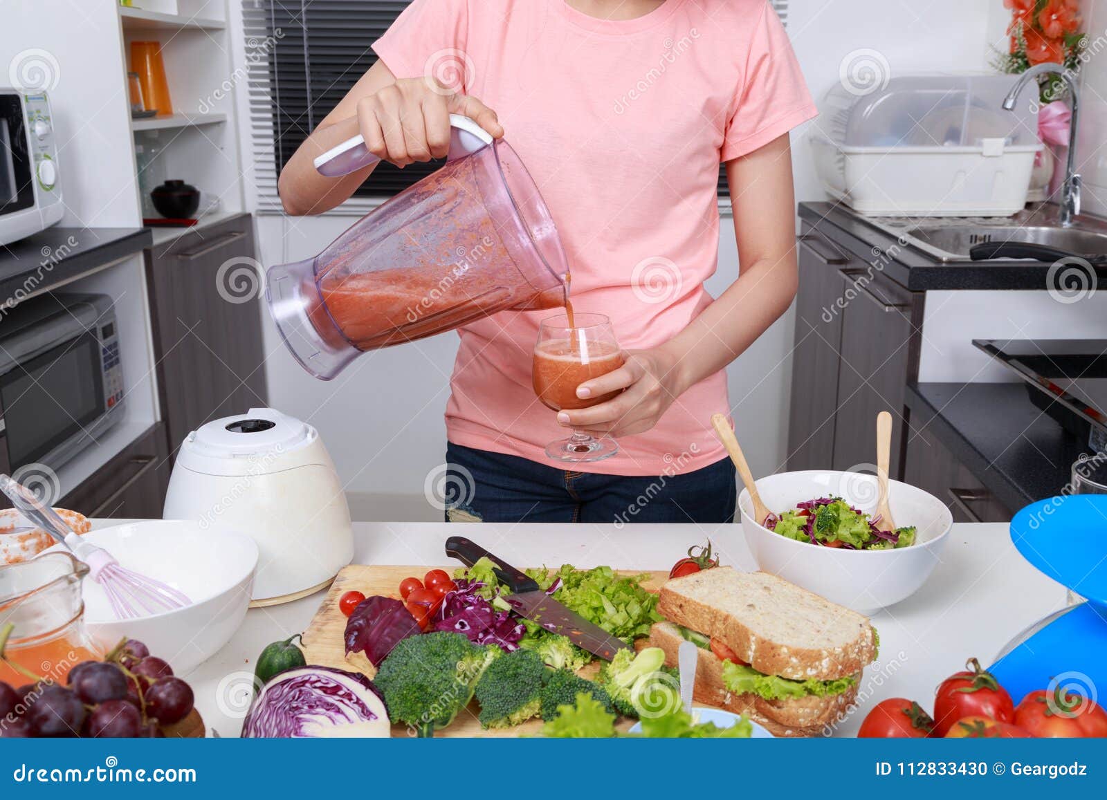 Woman Making Smoothies with Blender in Kitchen Stock Photo - Image of ...