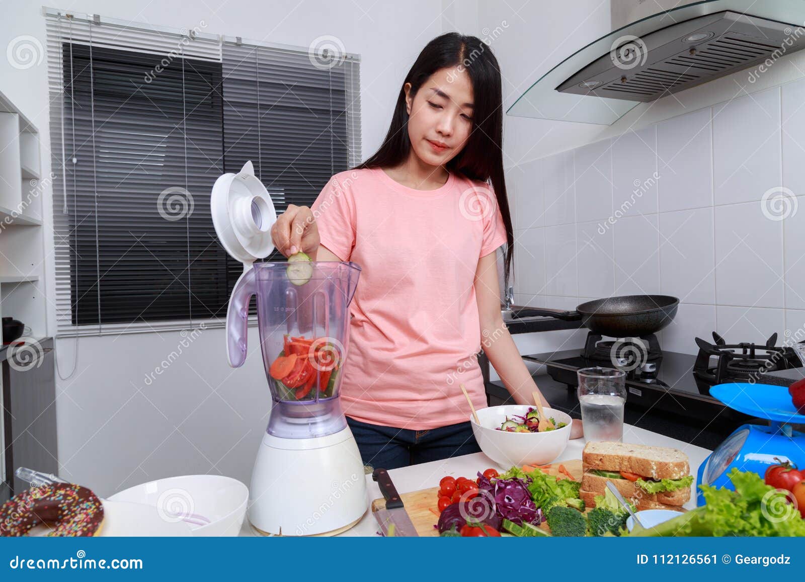 Woman Making Vegetable Smoothies with Blender in Kitchen Stock Image ...