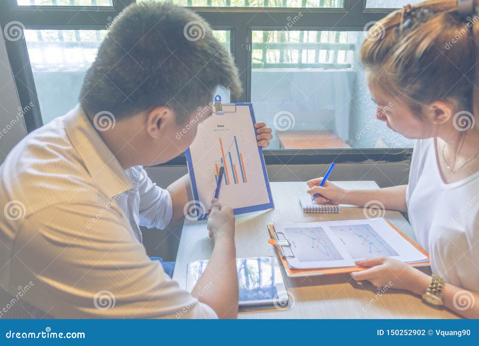 Woman and Man Having Sales Data Analysis Discussion at Work Stock Photo ...