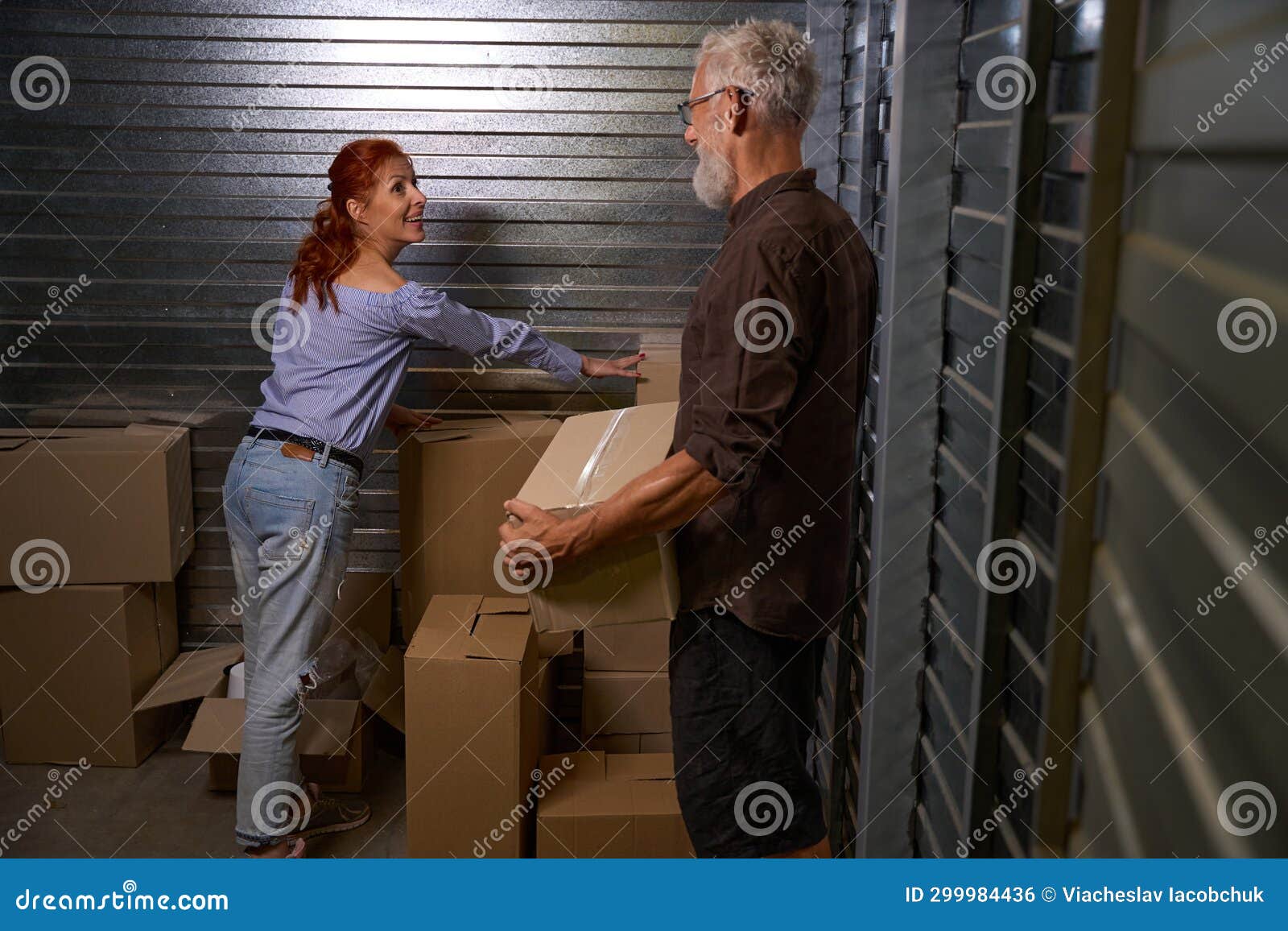 Woman and Man Loading Cardboard Boxes with Things into Storage ...