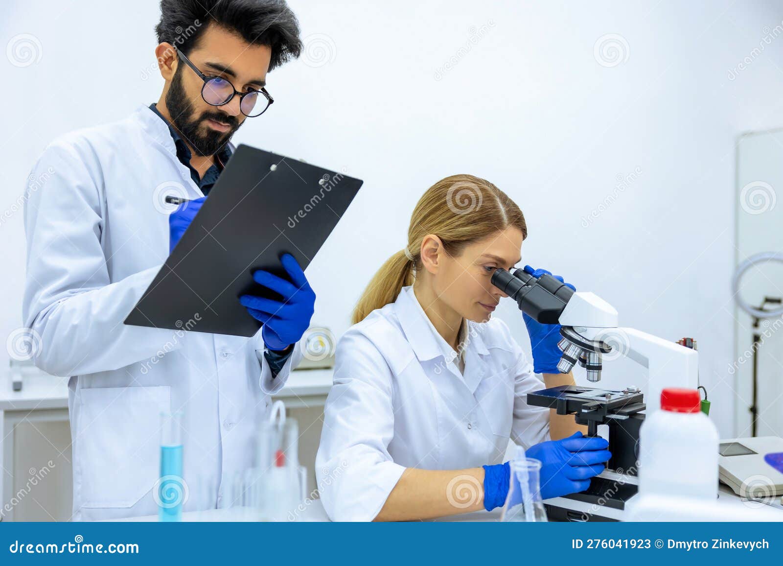 Woman and Man Scientists in Lab Coat Making Notes after Doing Sample ...