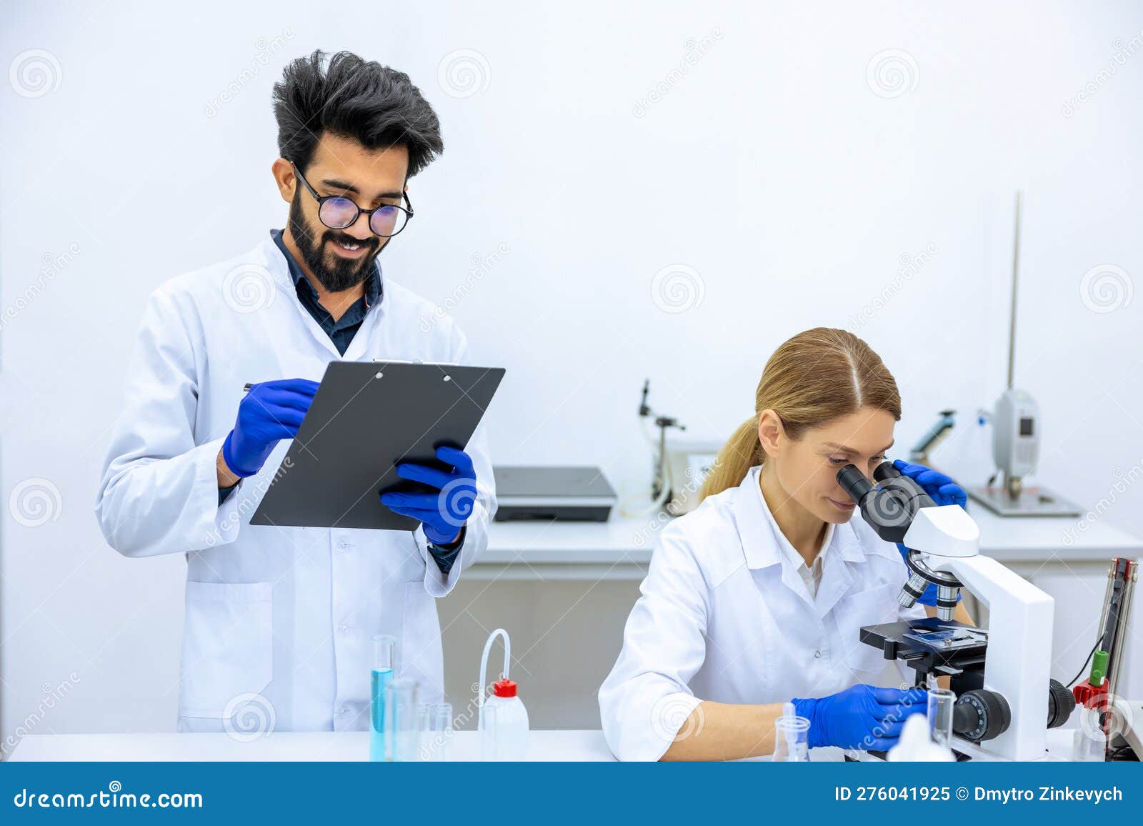 Woman and Man Scientists in Lab Coat Making Notes after Doing Sample ...