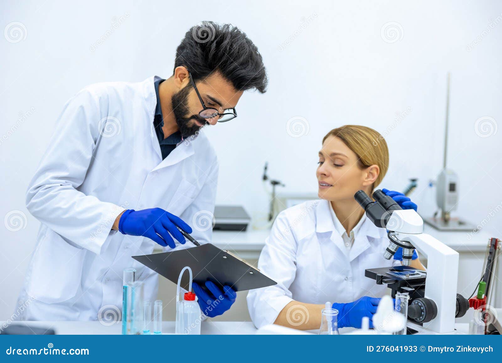 Woman and Man Scientists in Lab Coat Making Notes after Doing Sample ...