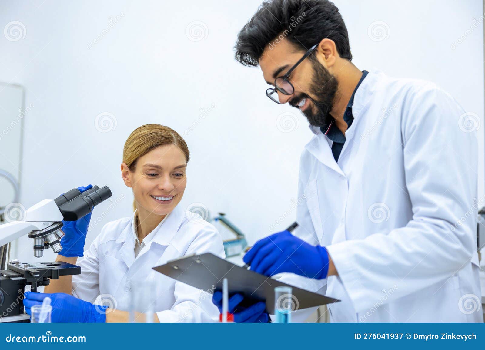 Woman and Man Scientists in Lab Coat Making Notes after Doing Sample ...