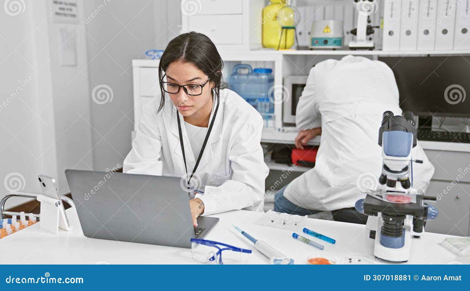 Woman and Man Scientists Researching in Laboratory with Microscope ...