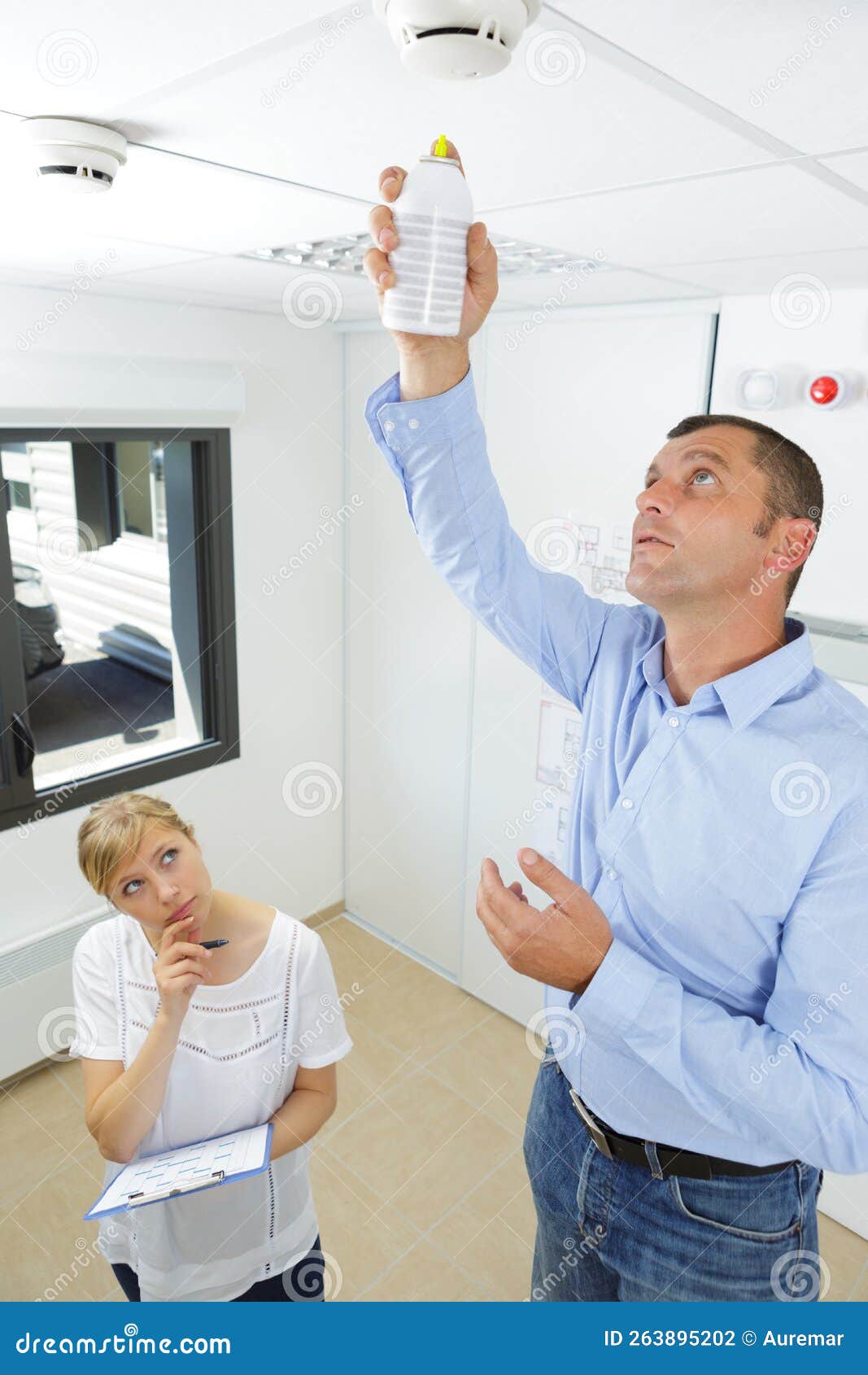 Woman and Man Testing Fire Alarm Stock Photo - Image of trigger, switch ...