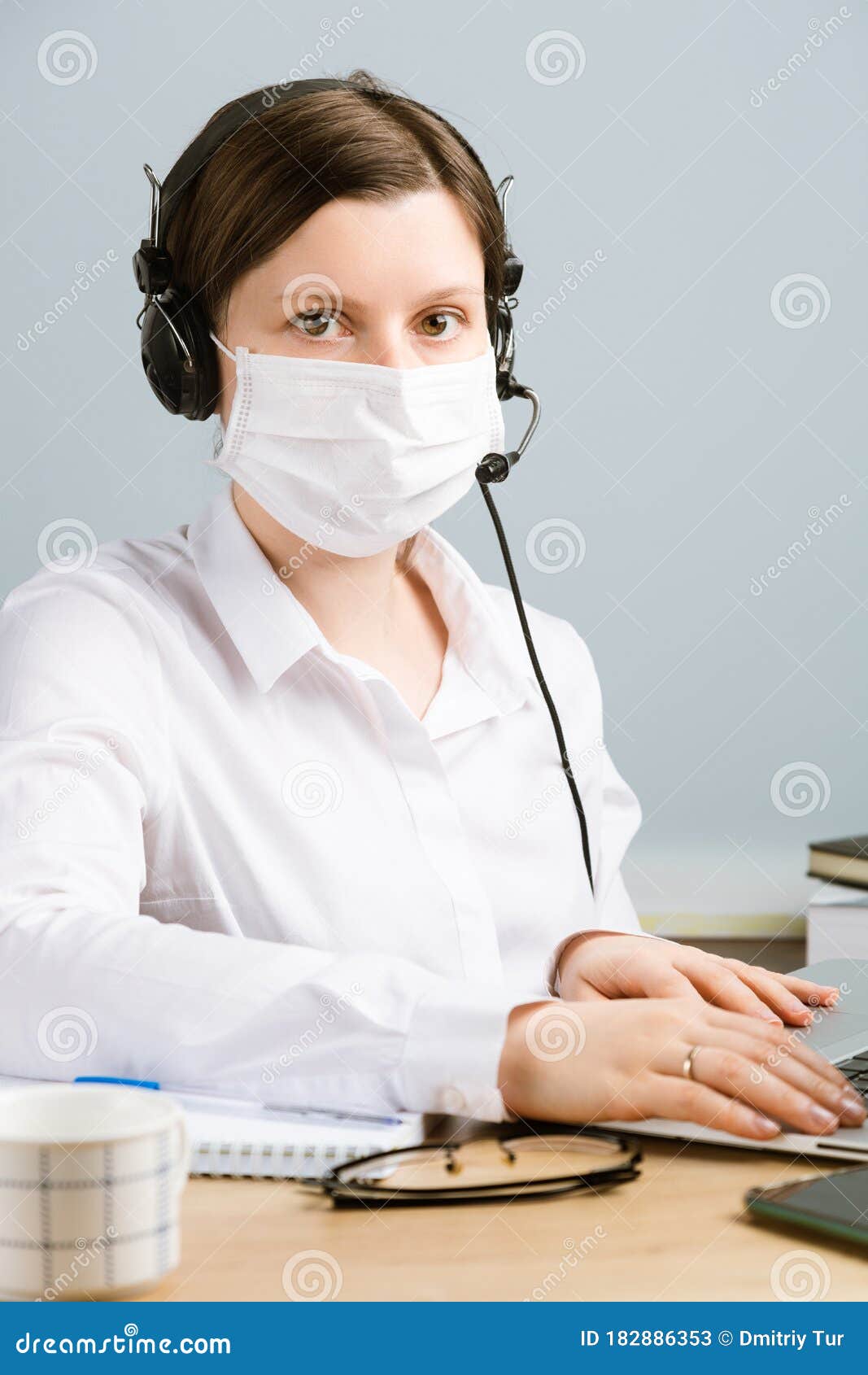 Woman in Mask with Headset, Using Computer and Notebook Stock Image ...