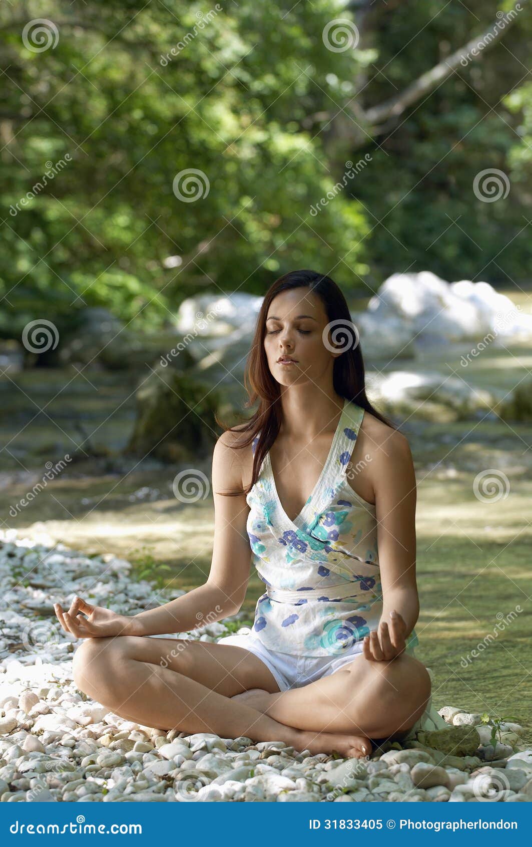 Woman Meditating In Lotus Position By Forest River Royalty Free Stock