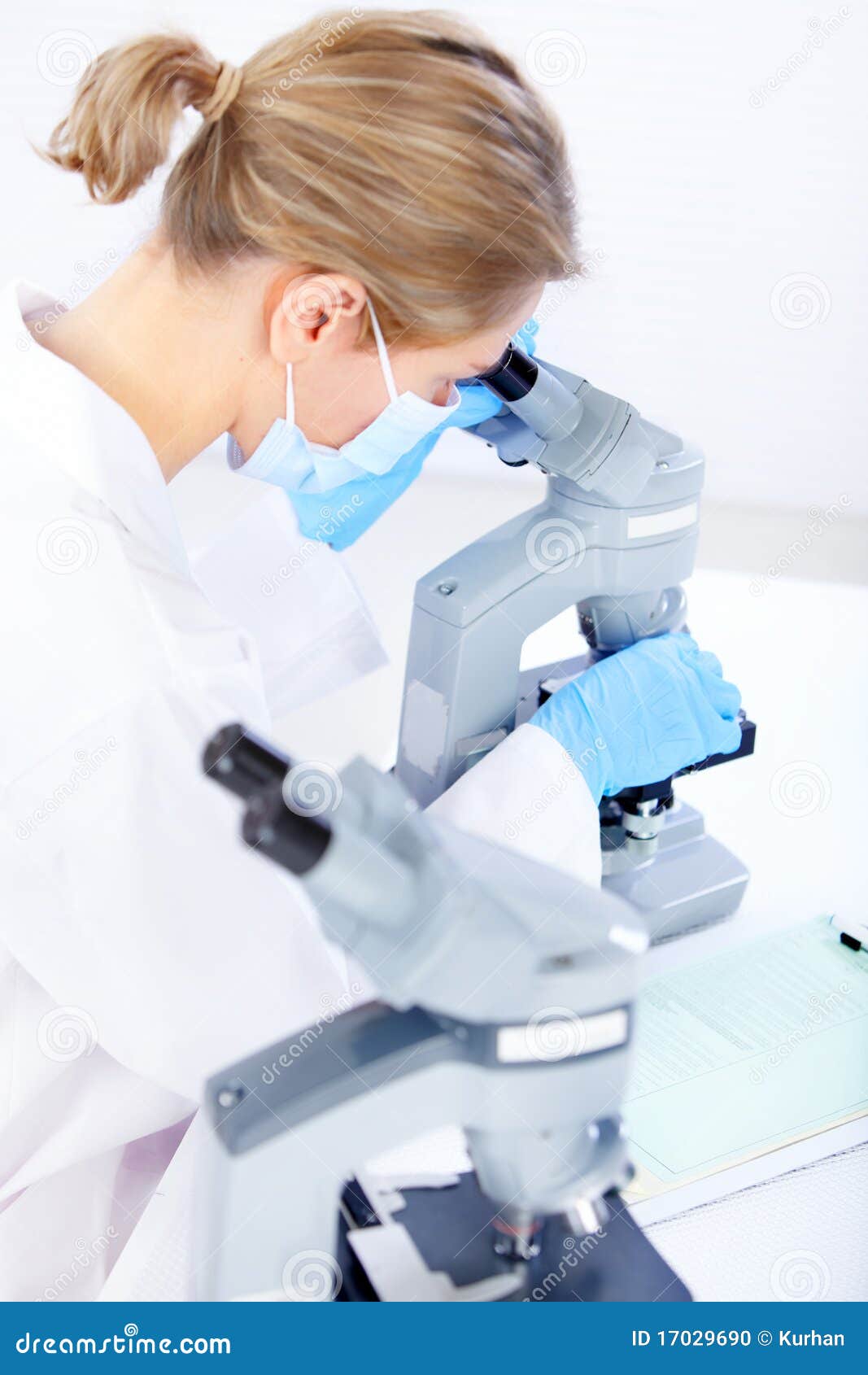 Woman with microscope stock photo. Image of education - 17029690